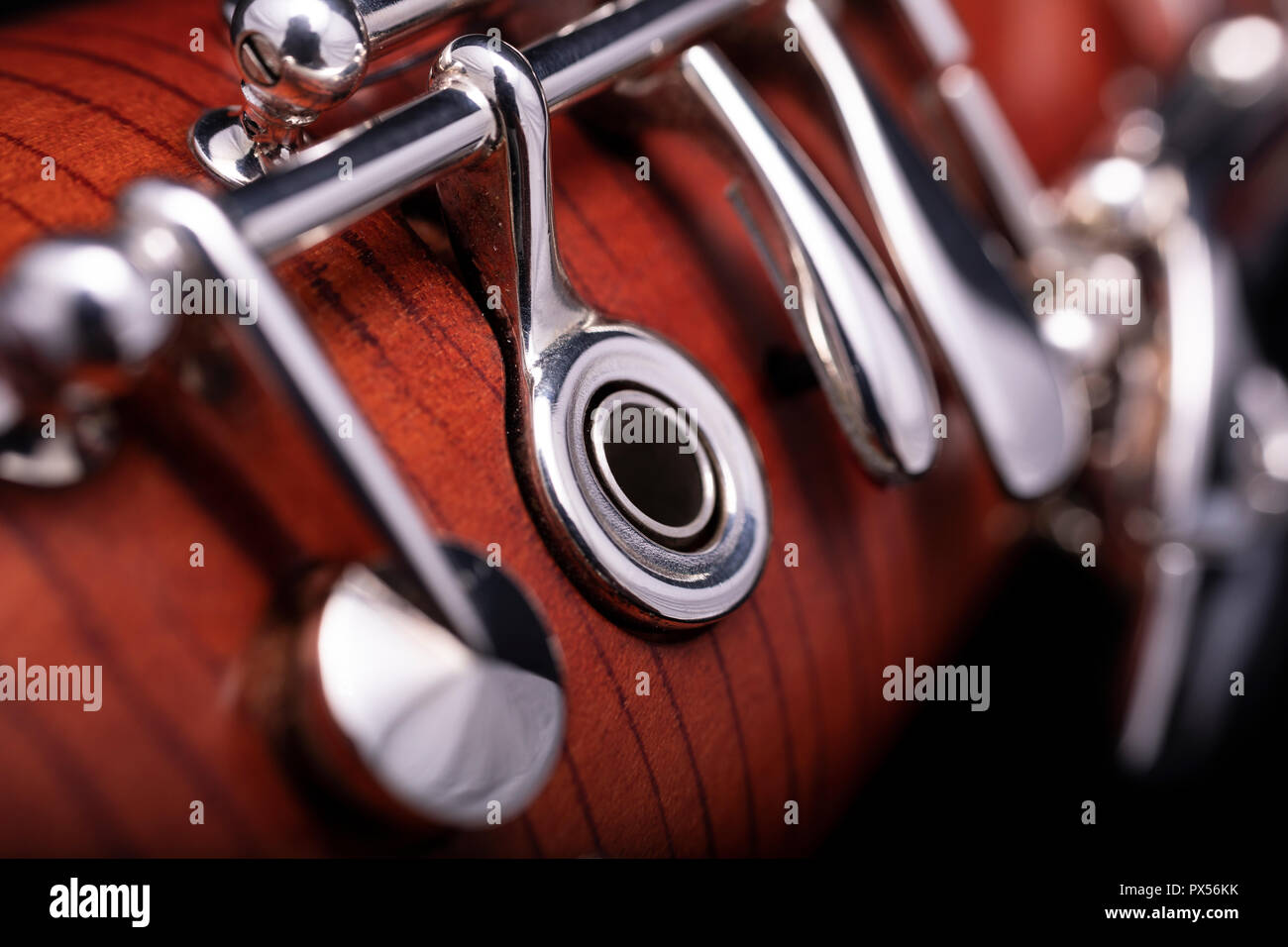 A part of a bassoon with silver plated keys on a black background Stock ...