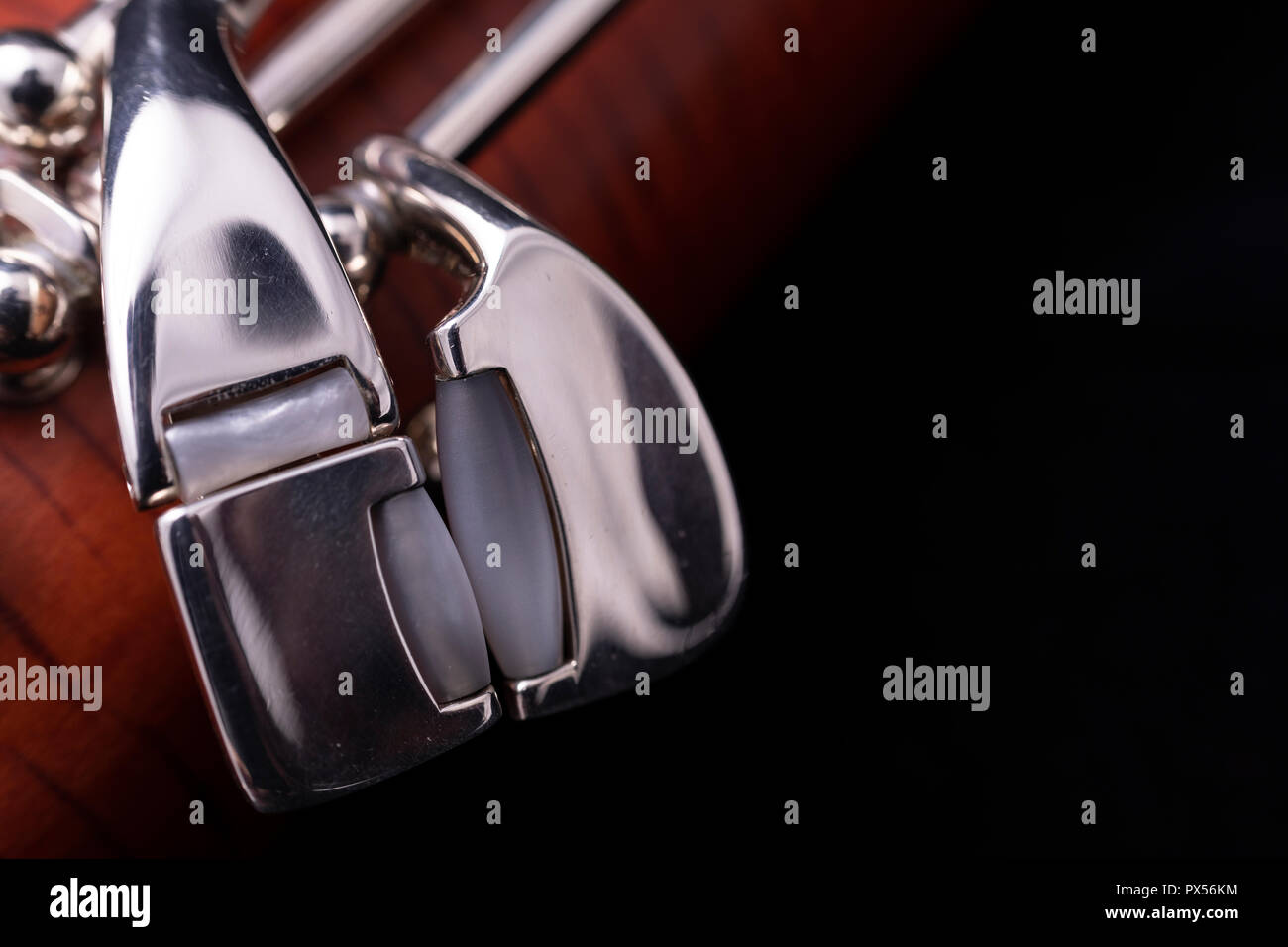 A part of a bassoon with silver plated keys on a black background Stock ...