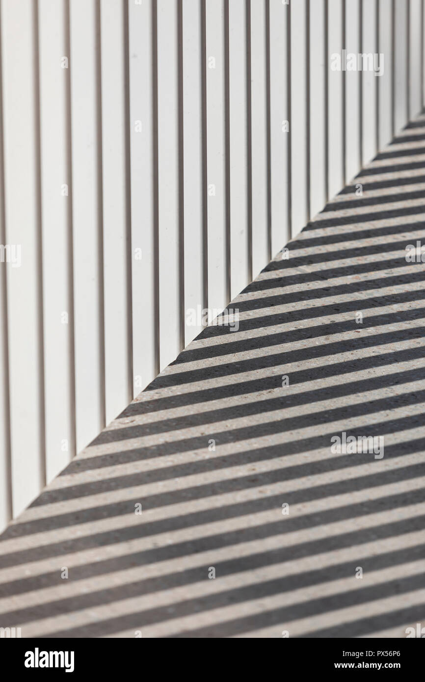 Shadows casted by a fence on a concrete sidewalk Stock Photo - Alamy