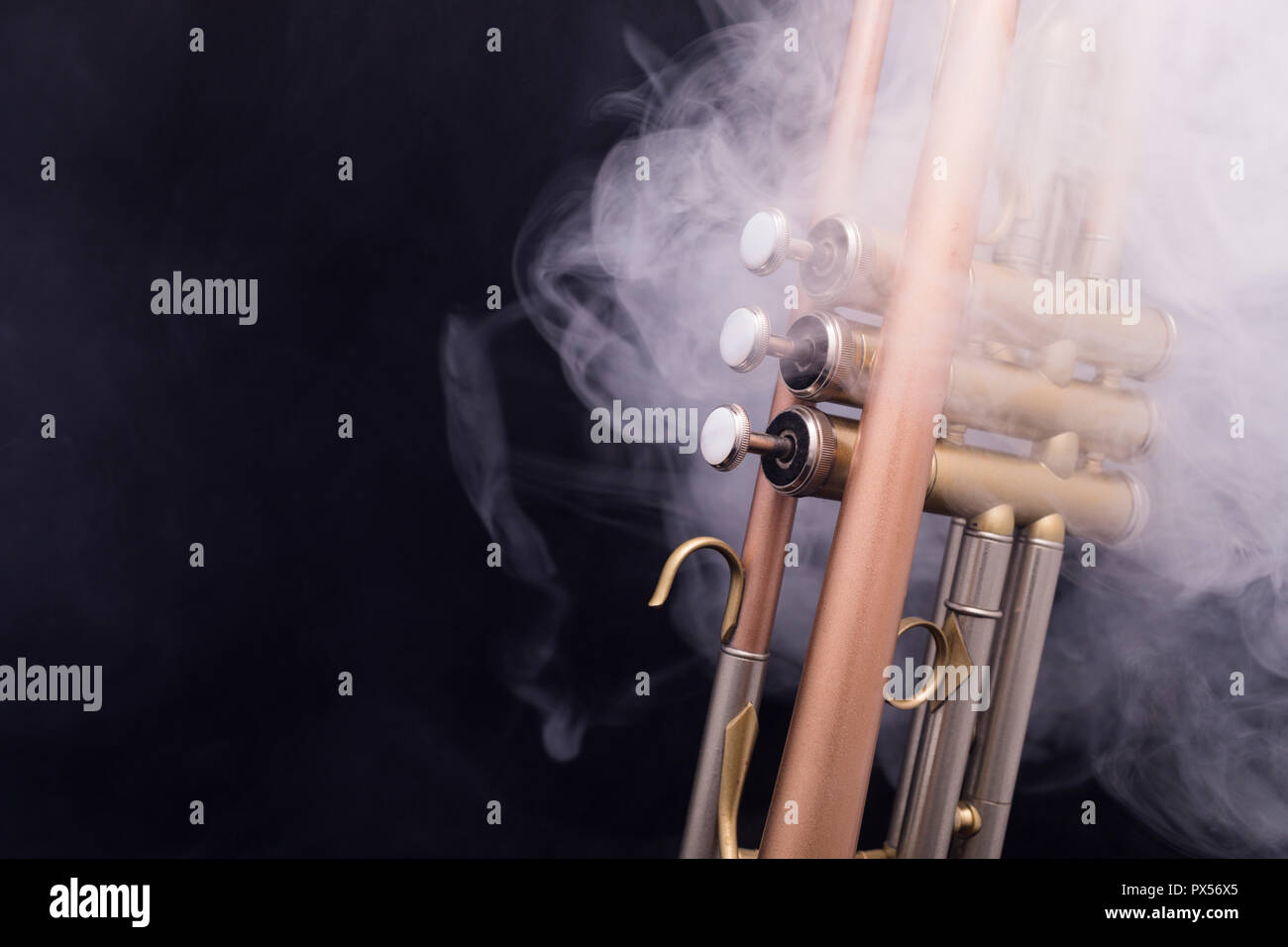 A tri color matt finish trumpet in smoke on a black background Stock ...