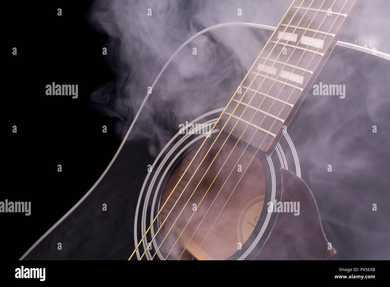A part of a black classical guitar in smoke on a black background Stock ...