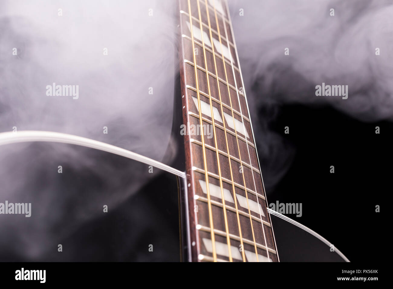 A part of a black classical guitar in smoke on a black background Stock ...