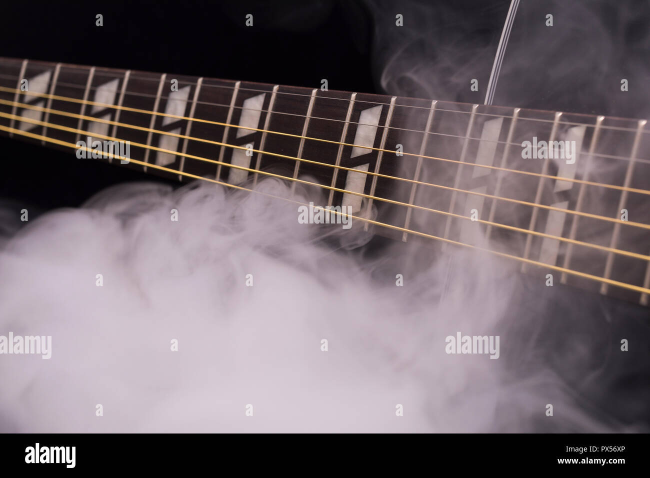 A part of a black classical guitar in smoke on a black background Stock ...