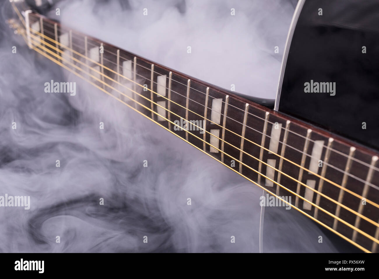 A part of a black classical guitar in smoke on a black background Stock ...