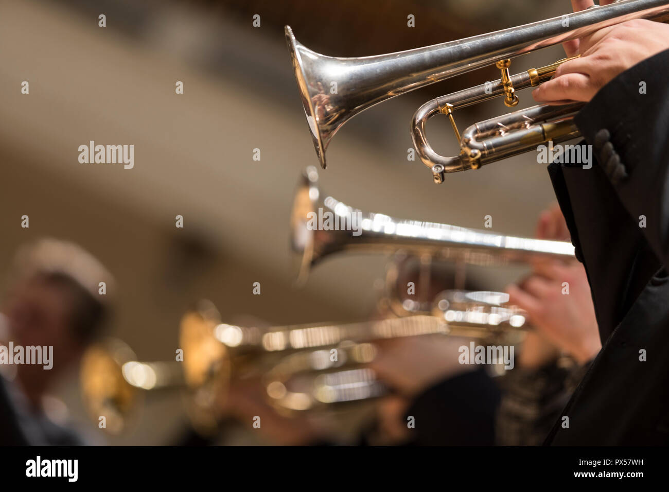 People playing silver plated trumpets during a concert Stock Photo - Alamy