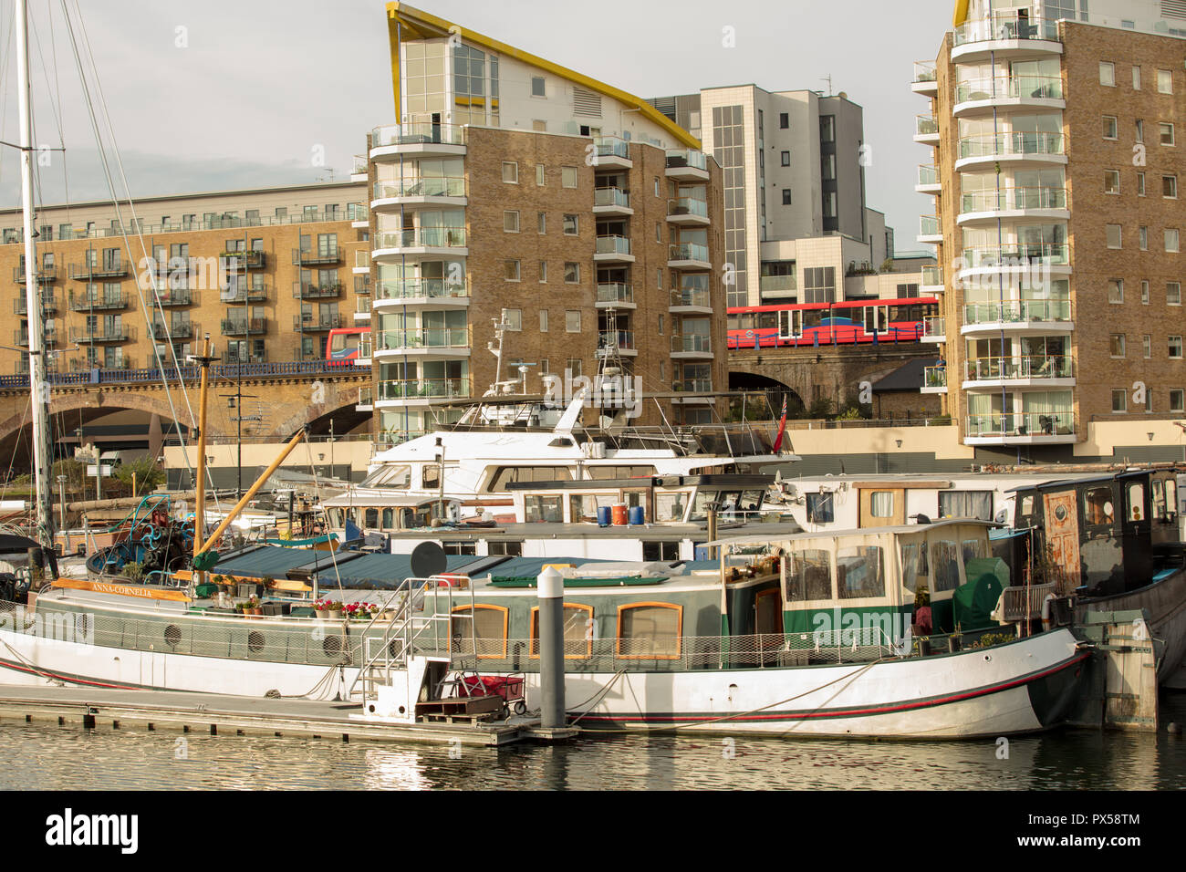 River barges and larger boats attached securely to the moorings of the ...