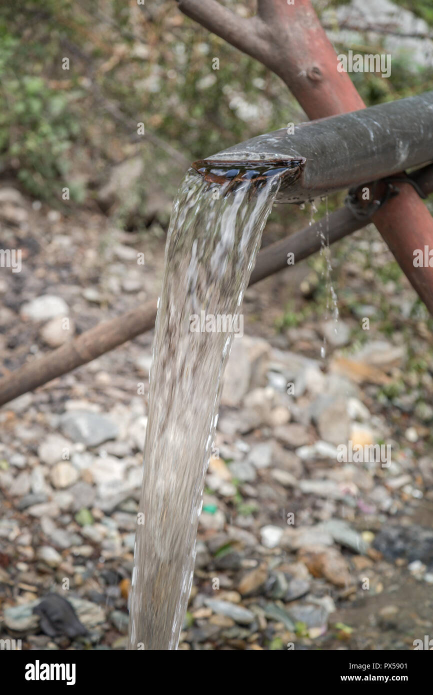 Spring Water Comes Out Of steel pipe in hilly area of uttarakhand Stock ...