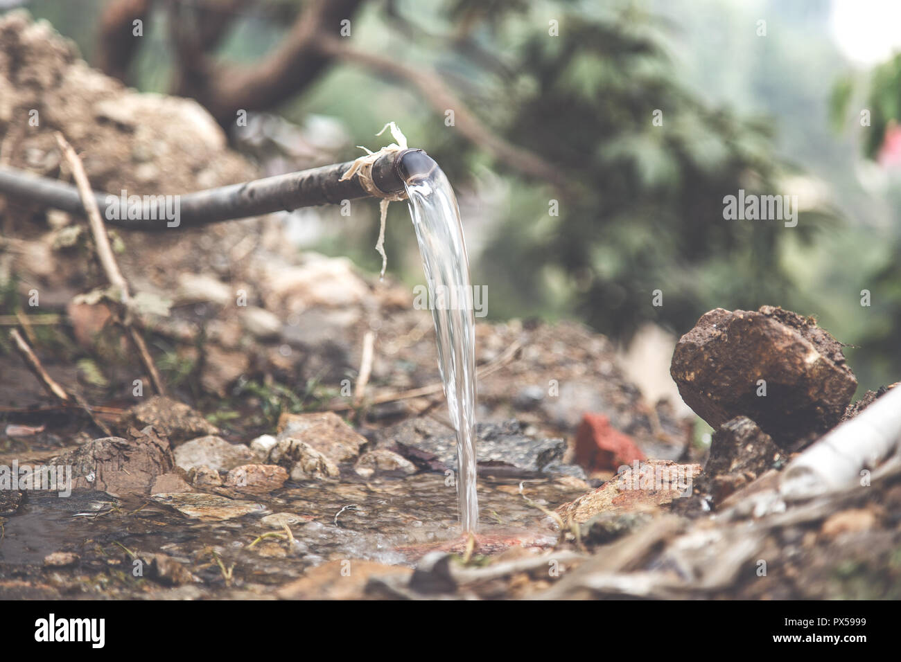 Fresh village water flowing out from a broken steel pipe Stock Photo ...