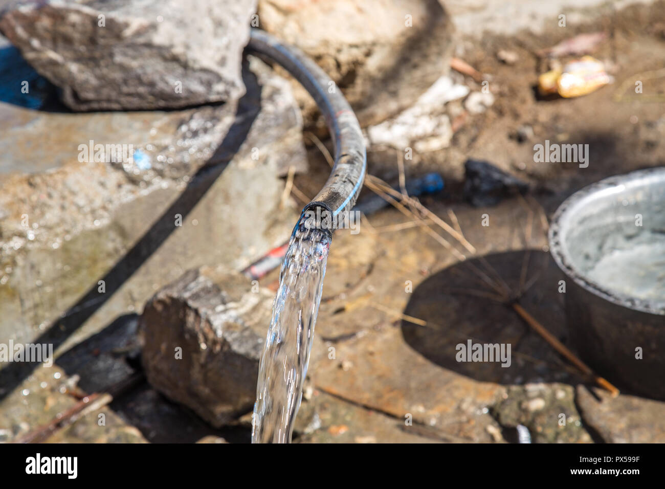 Fresh village water flowing out from a broken steel pipe Stock Photo ...
