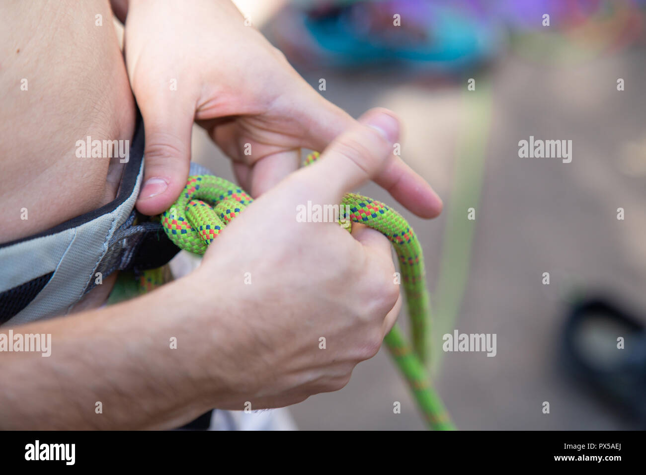 Close up of climber making a knot called double eight with the rope in ...