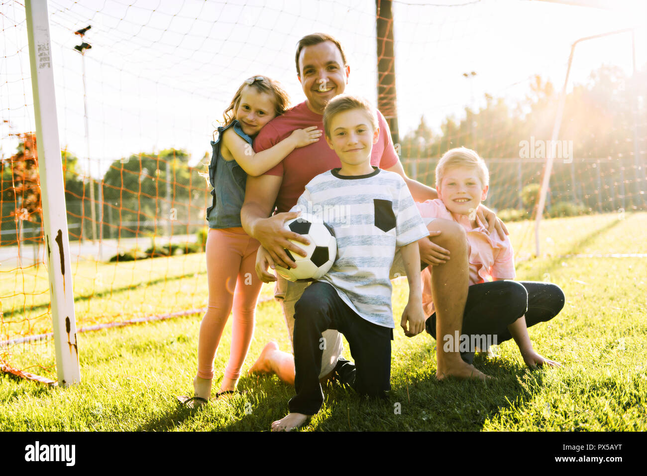 Happy family lifestyle play soccer outside Stock Photo - Alamy