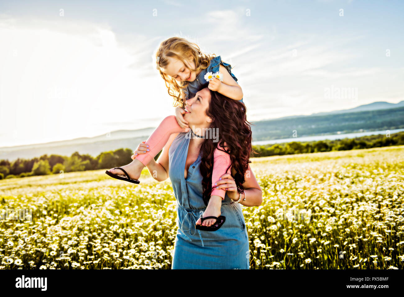Mother spending time with daughter during the sunset Stock Photo - Alamy