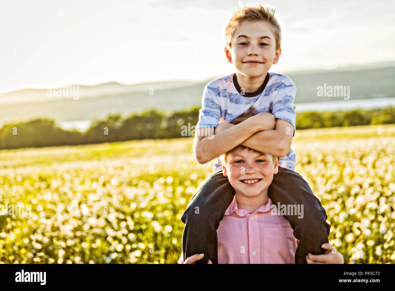Portrait of two happy cheerful brothers at sunset, outdoor Stock Photo ...