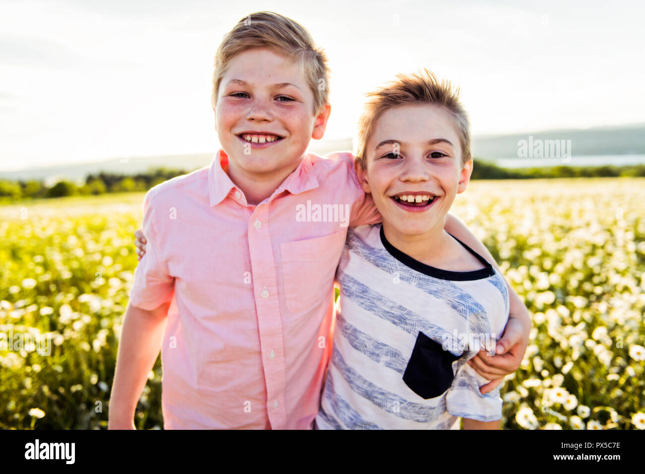 Portrait of two happy cheerful brothers at sunset, outdoor Stock Photo ...