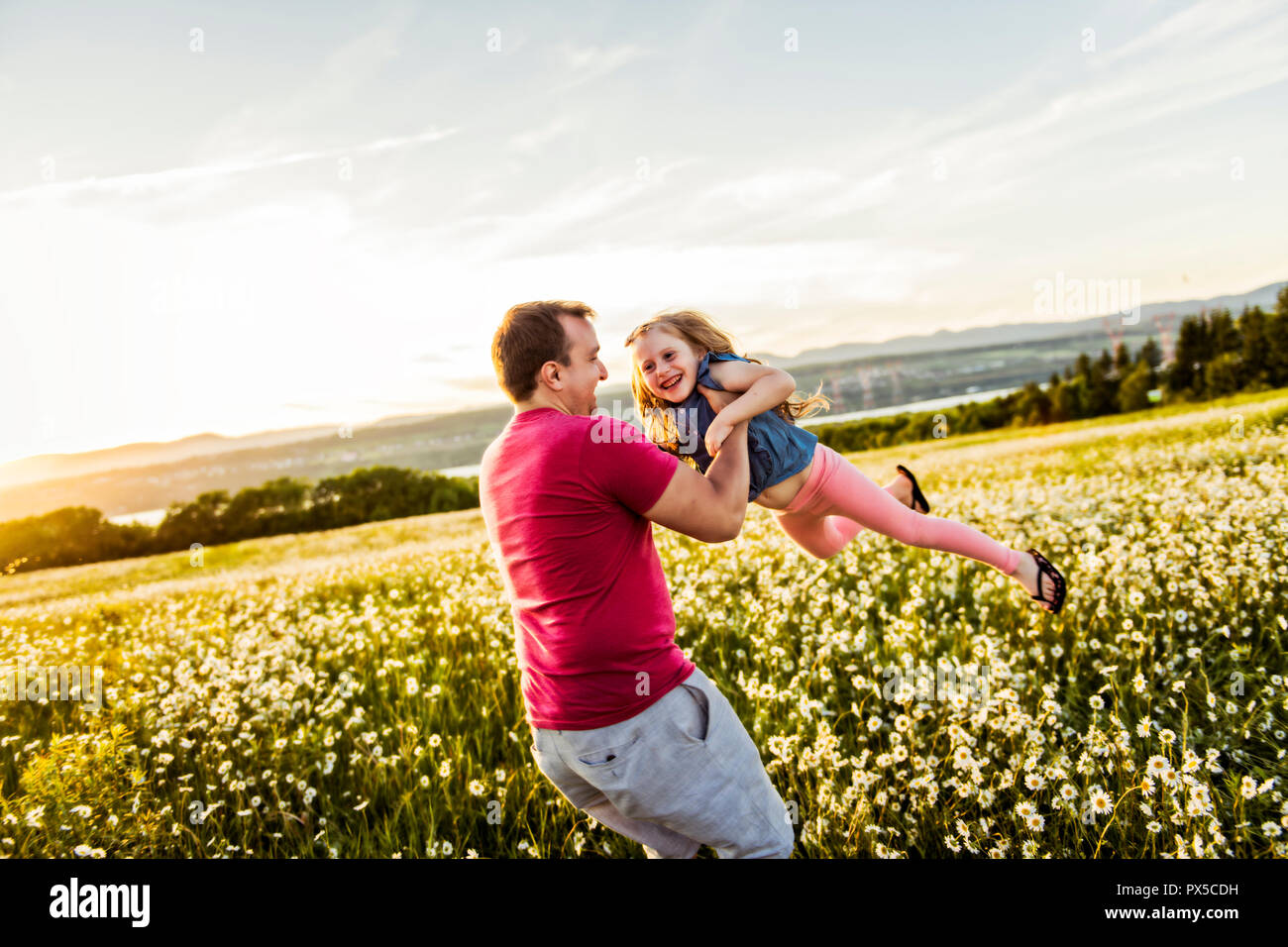 Father spending time with daughter during the sunset Stock Photo - Alamy