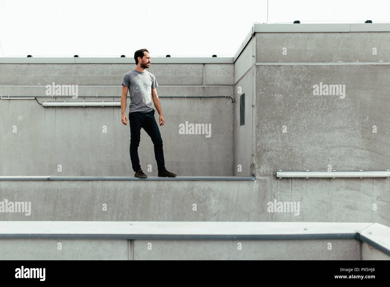 Man standing on the wall hi-res stock photography and images - Alamy