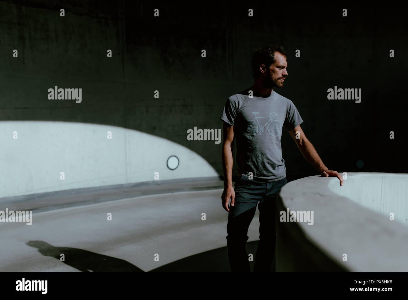 photo of young worried man who is waiting inside a parking garage Stock ...