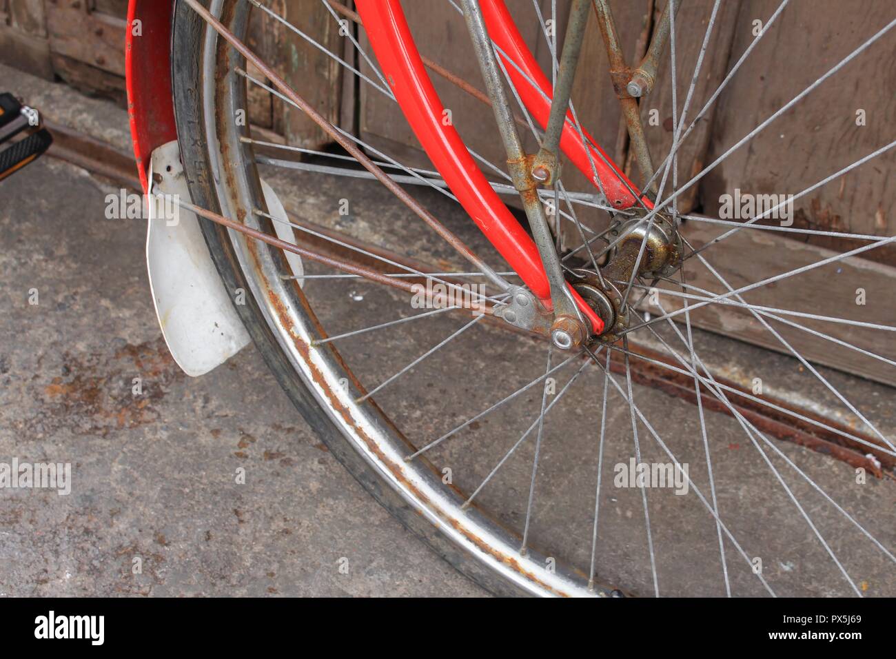 Vintage wheel for bicycle old style rusty on wall wood background Stock ...