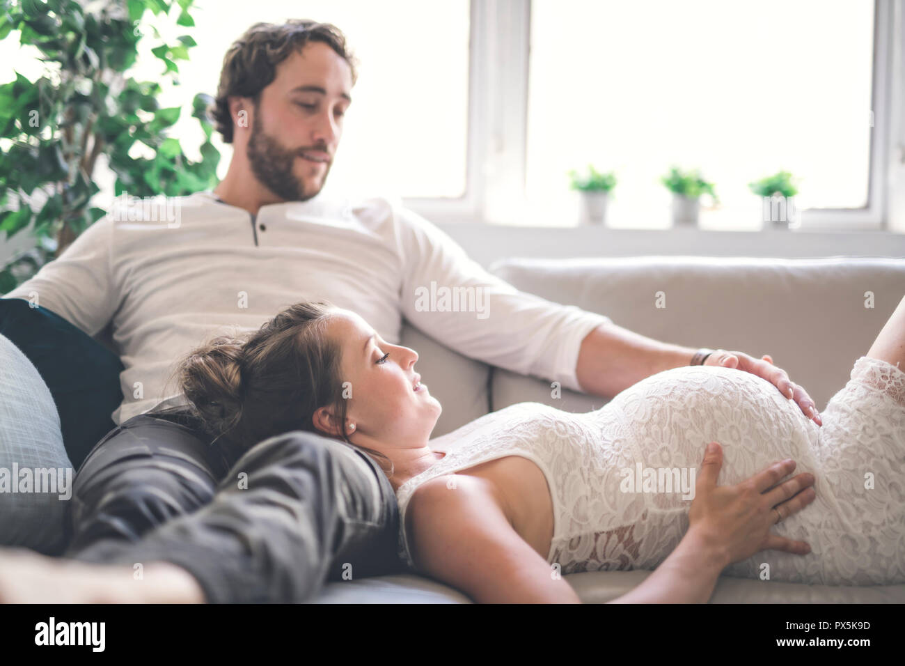 Expecting female lying on couch hi-res stock photography and images - Alamy