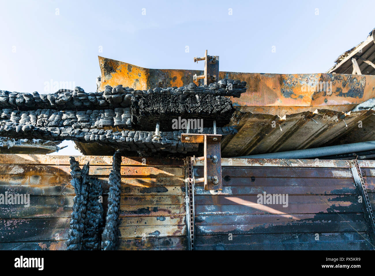 Damaged industry supermarket after arson fire with burn debris of ...