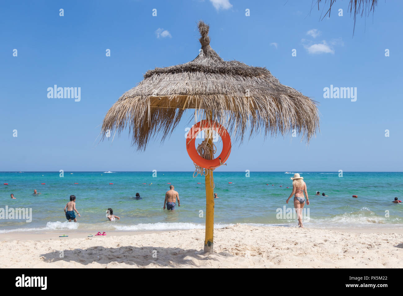 Beach umbrella with life-saving equipment and the Mediterranean Sea ...