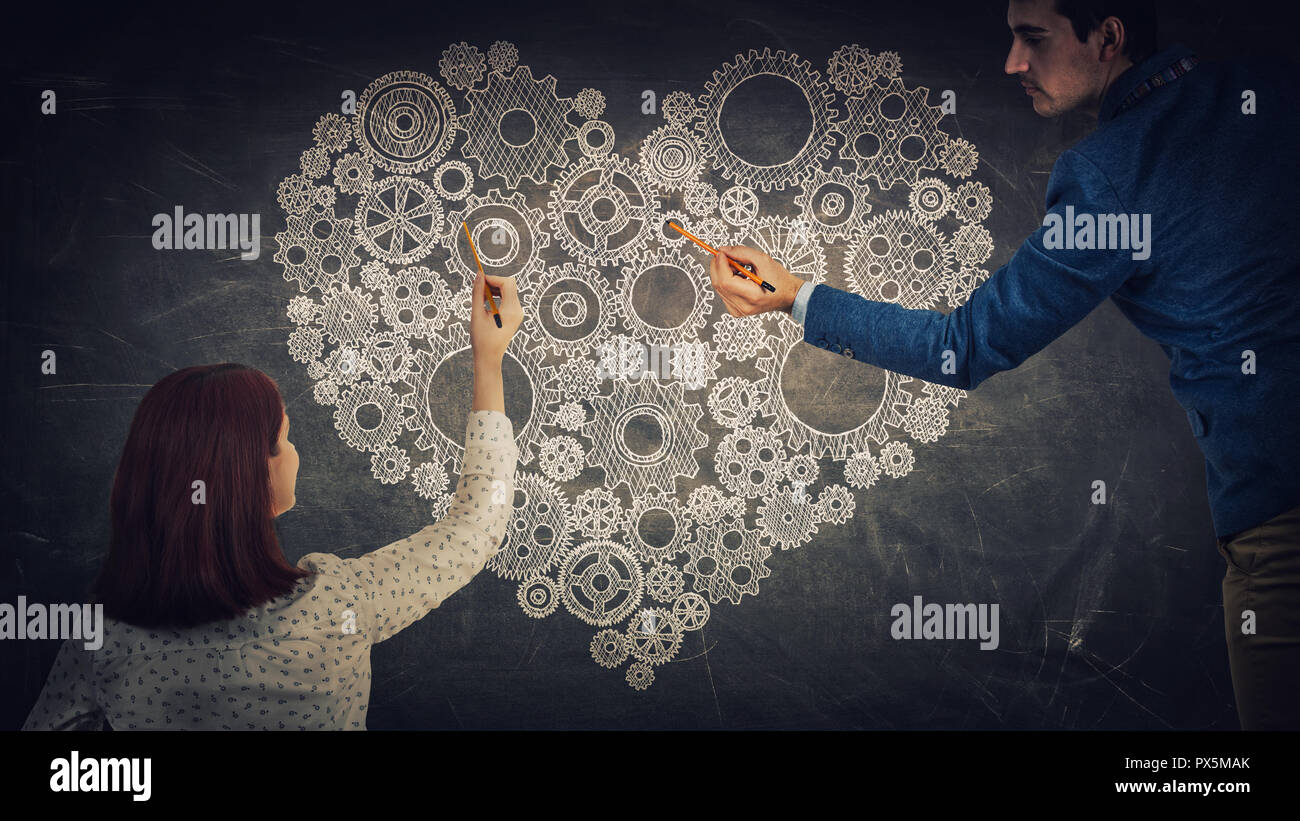 Man and woman sharing thoughts together drawing a big cog heart on ...
