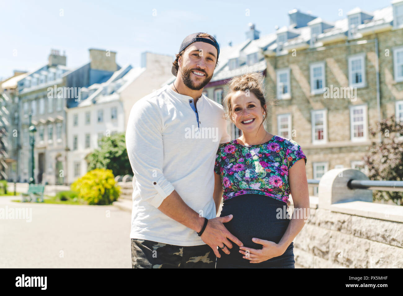 A Pregnant couple portrait outside in the neighborhood Stock Photo - Alamy