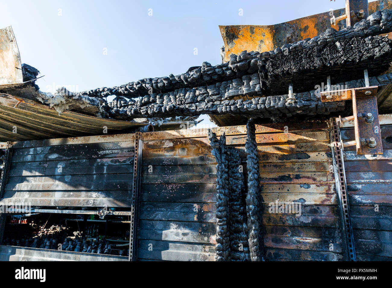 Damaged industry supermarket after arson fire with burn debris of ...