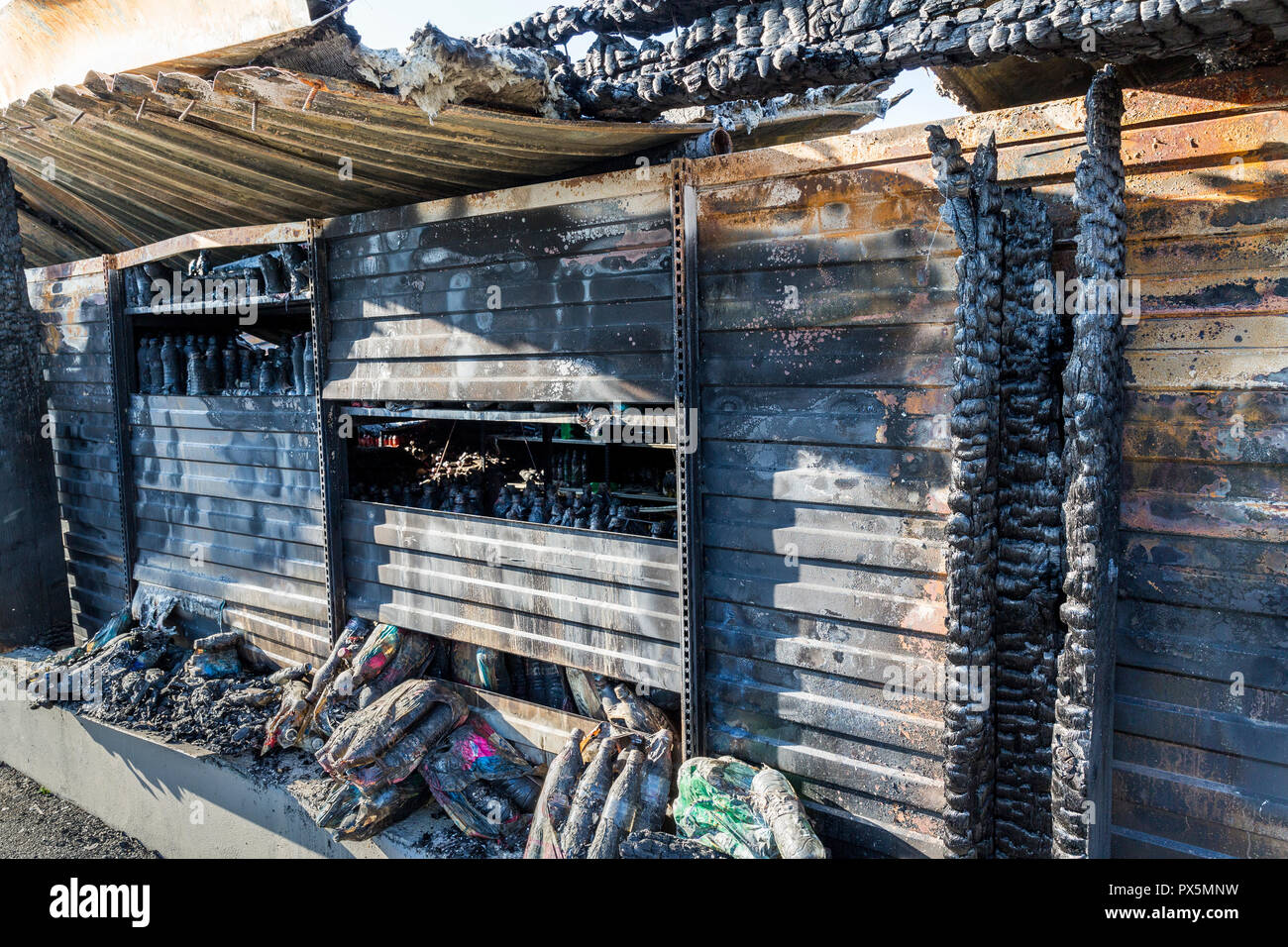 Close up damaged industry supermarket metallic facade after arson fire ...