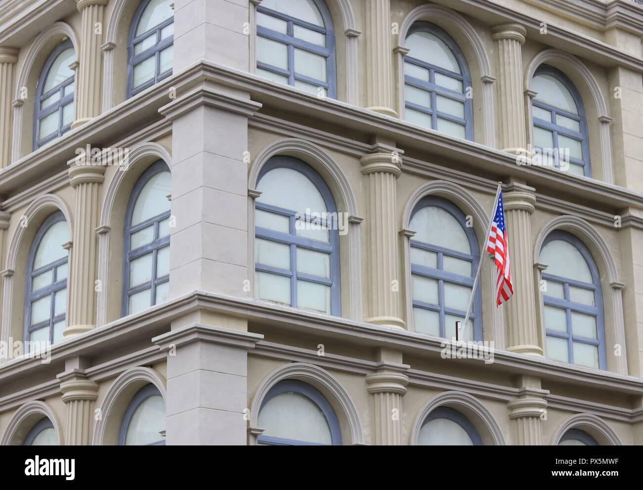American flag on building, the proudly displaying their Stock Photo - Alamy