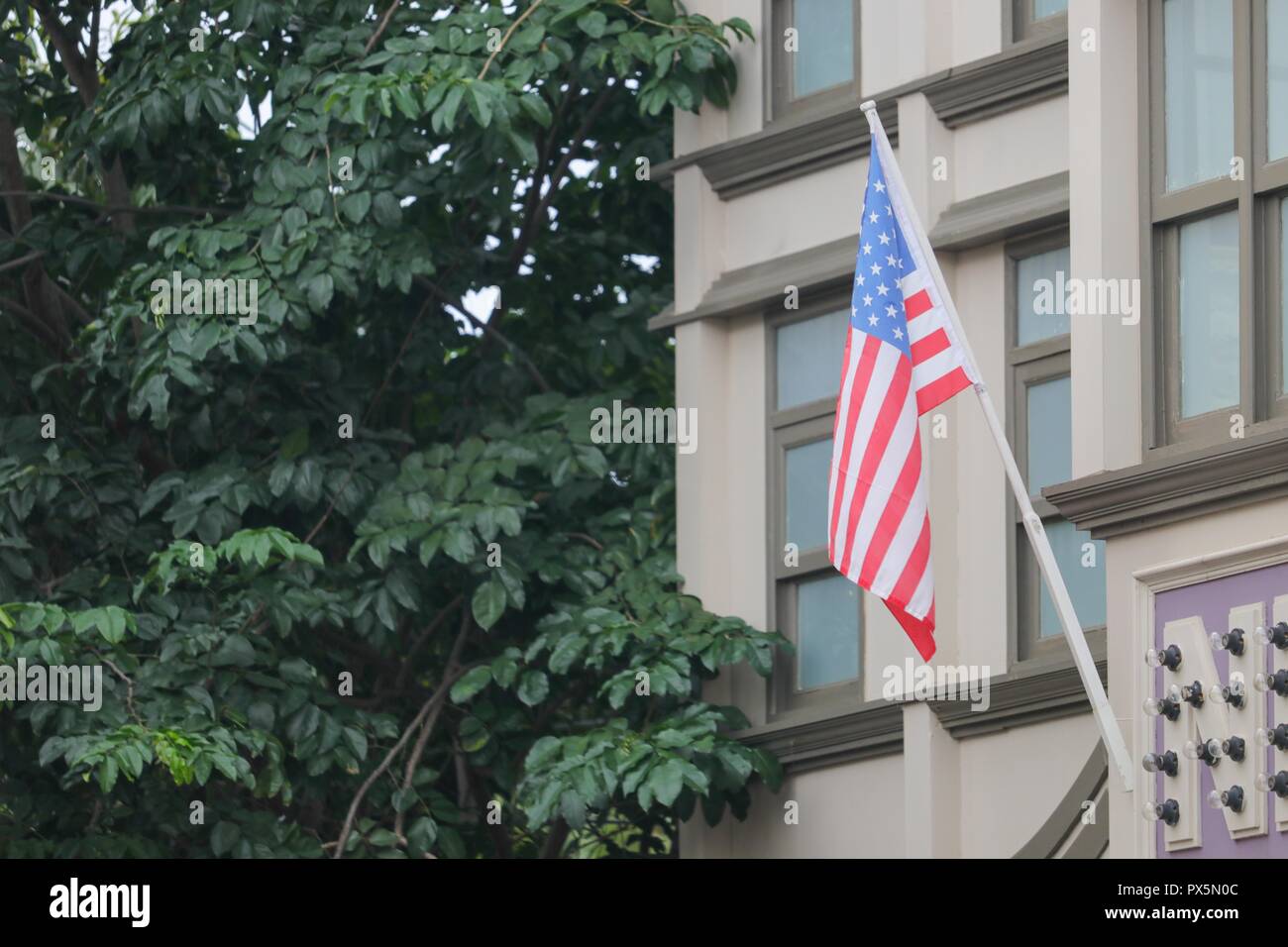 American flag on building, the proudly displaying their Stock Photo - Alamy