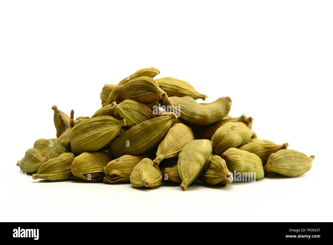 Green cardamom spice on white background Stock Photo - Alamy