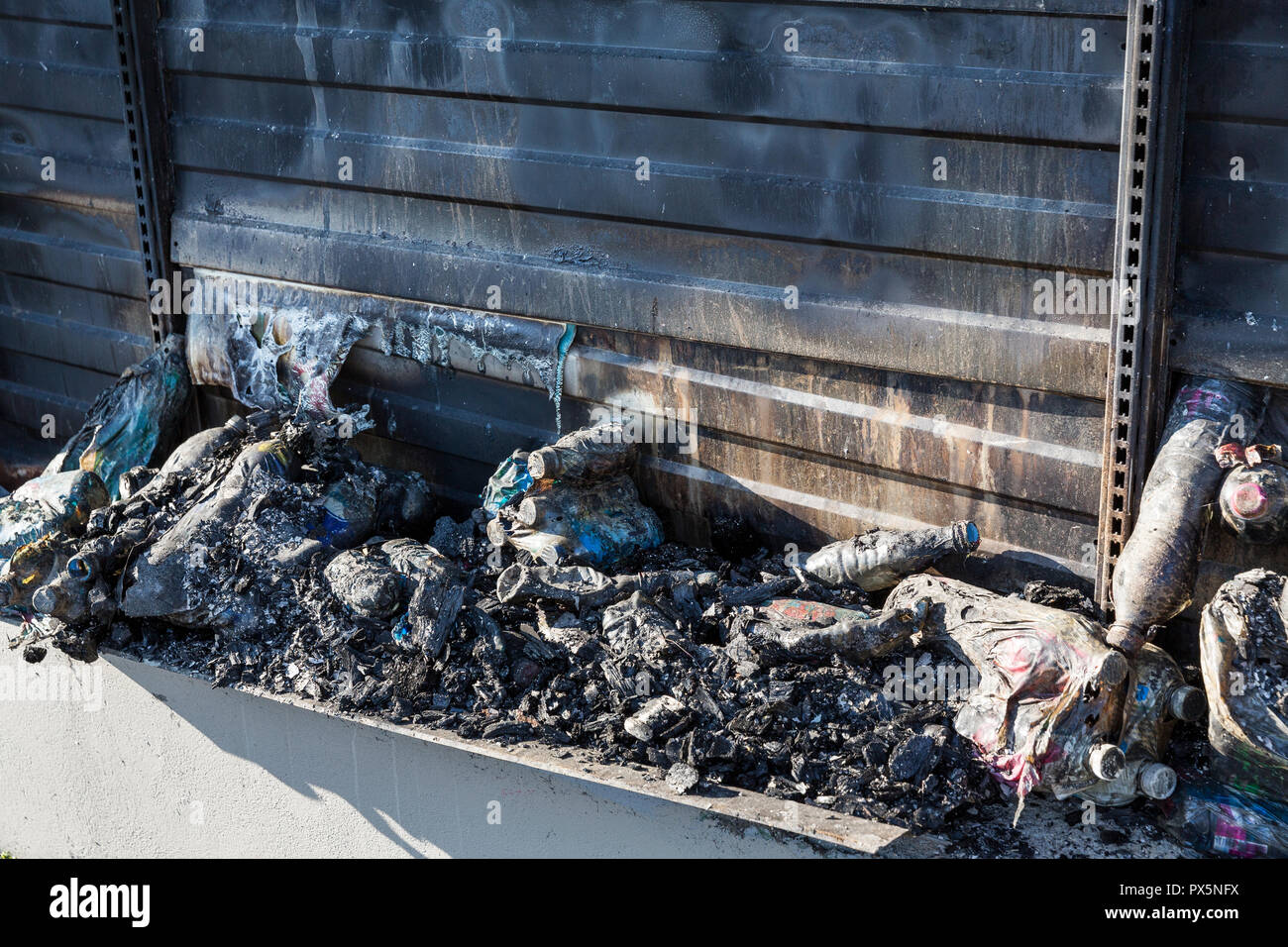 Close up damaged industry supermarket metallic facade after arson fire ...