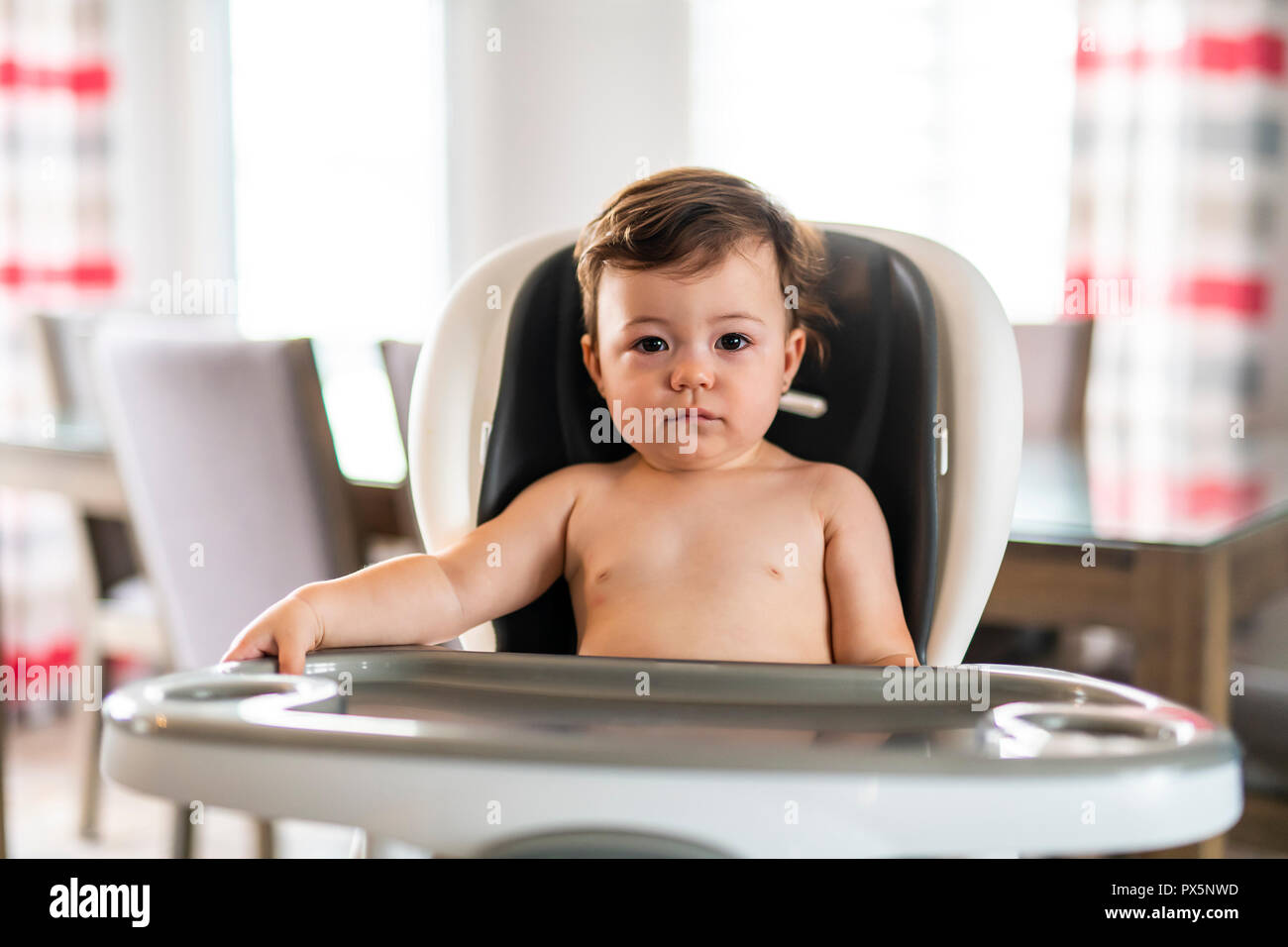 A cheerful happy baby child sitting in chair Stock Photo - Alamy