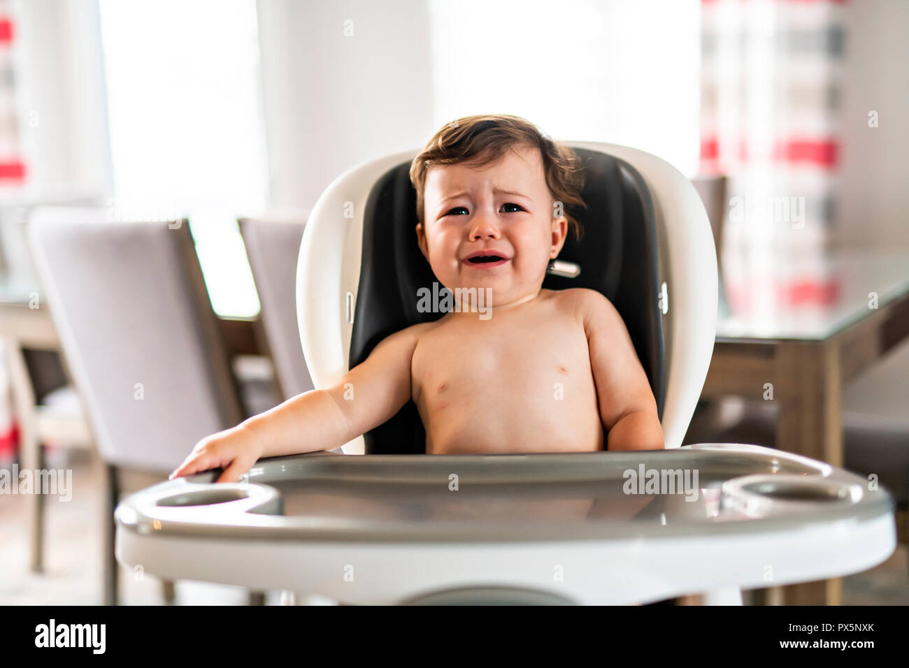 A cheerful happy baby child sitting in chair Stock Photo - Alamy