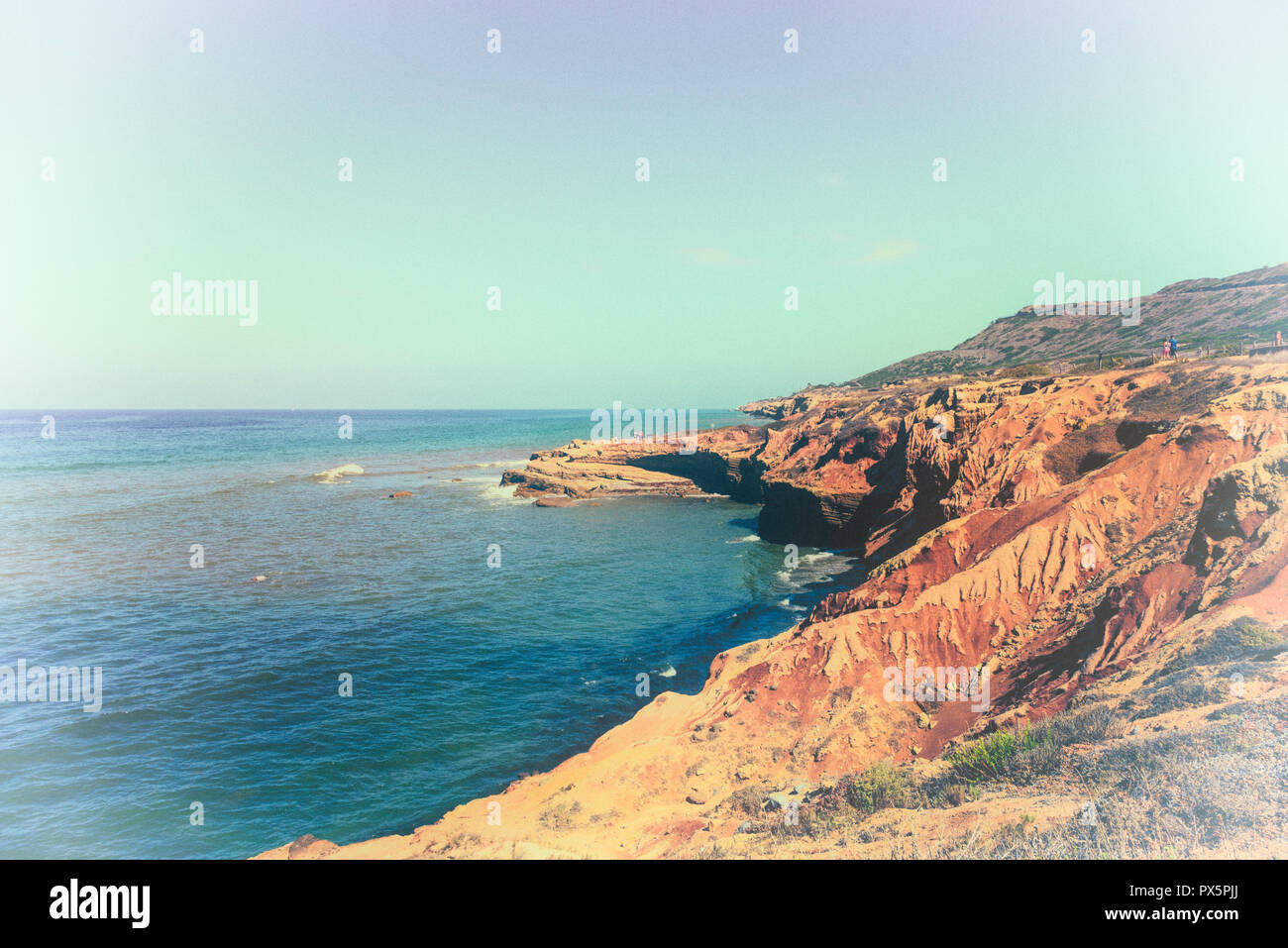 California coastline with blue ocean rocky beach under blue sky Stock ...