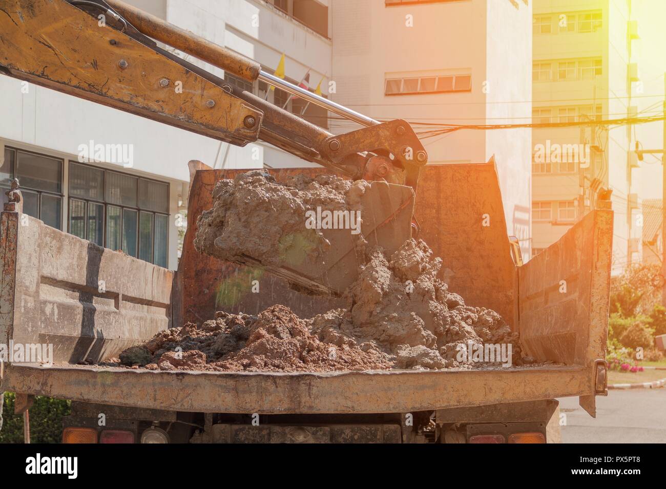 Excavator or soil, mud into truck body, Work and motion soil mud with ...