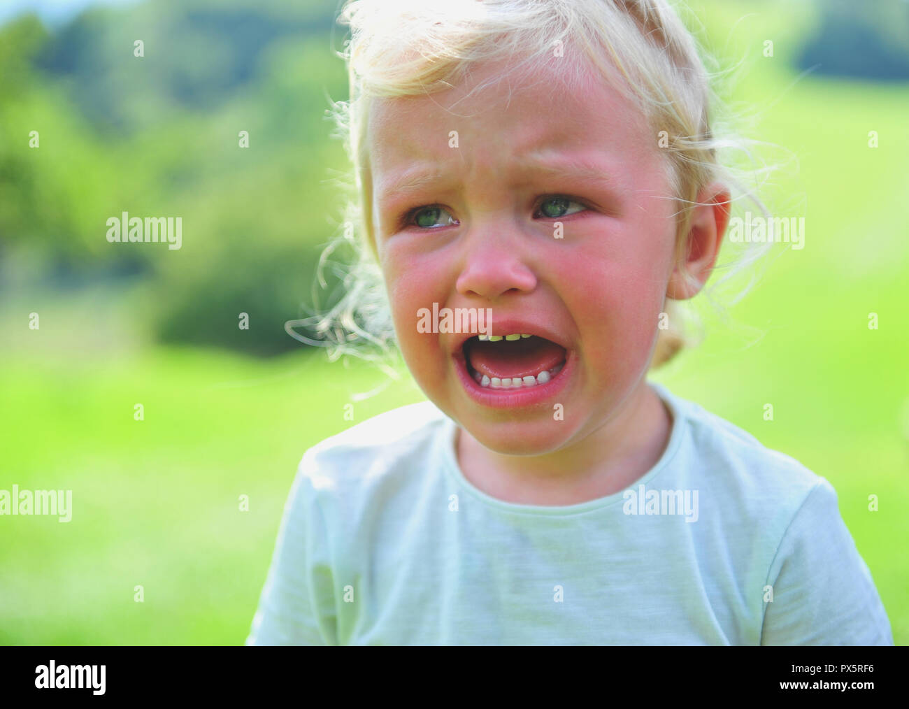 Portrait of little girl crying outdoors Stock Photo - Alamy