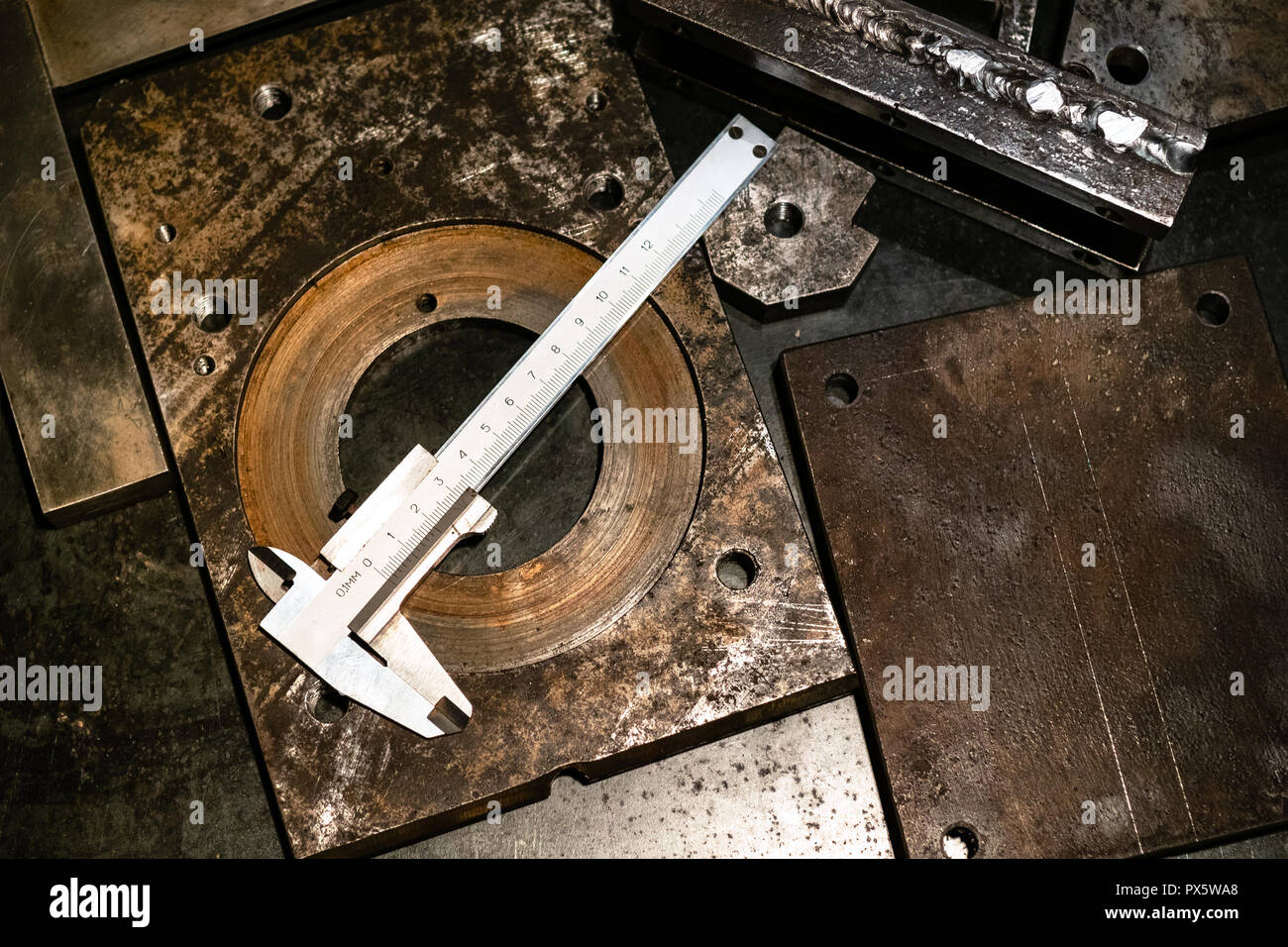 Metalworking still life - top view of callipers on metal workbench in ...