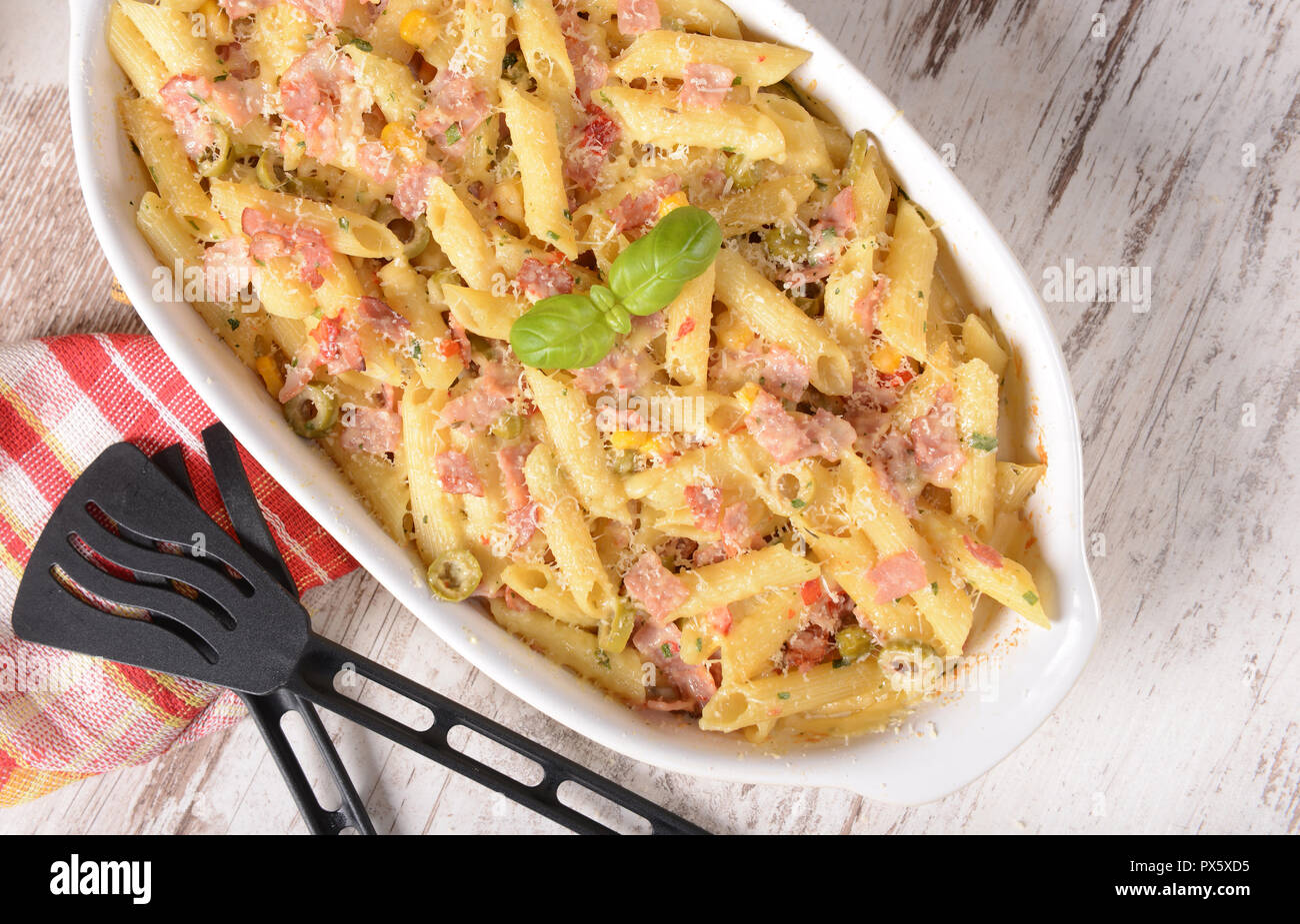 Penne pasta casserole with cheese, ham and corn Stock Photo - Alamy