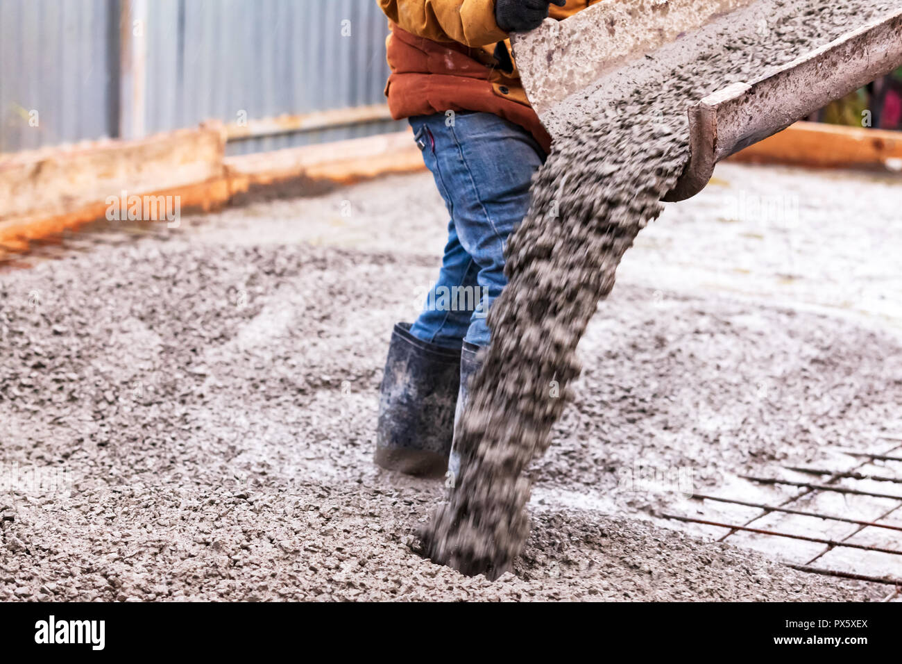 Closeup shot of concrete casting on reinforcing metal bars of floor in ...