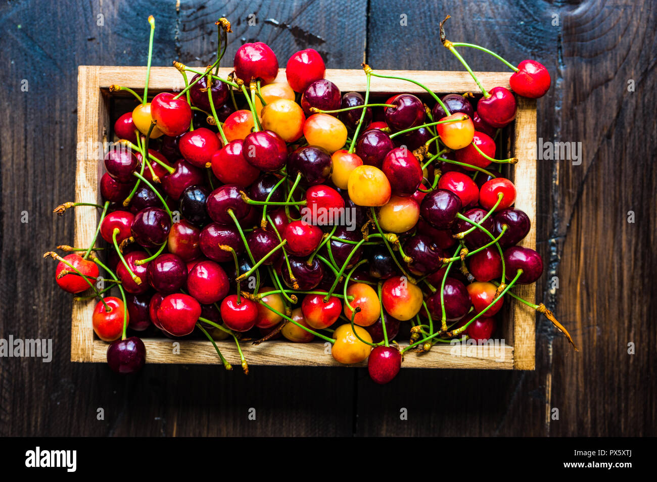 Fresh organic sweet cherries in wooden box with copy space Stock Photo ...