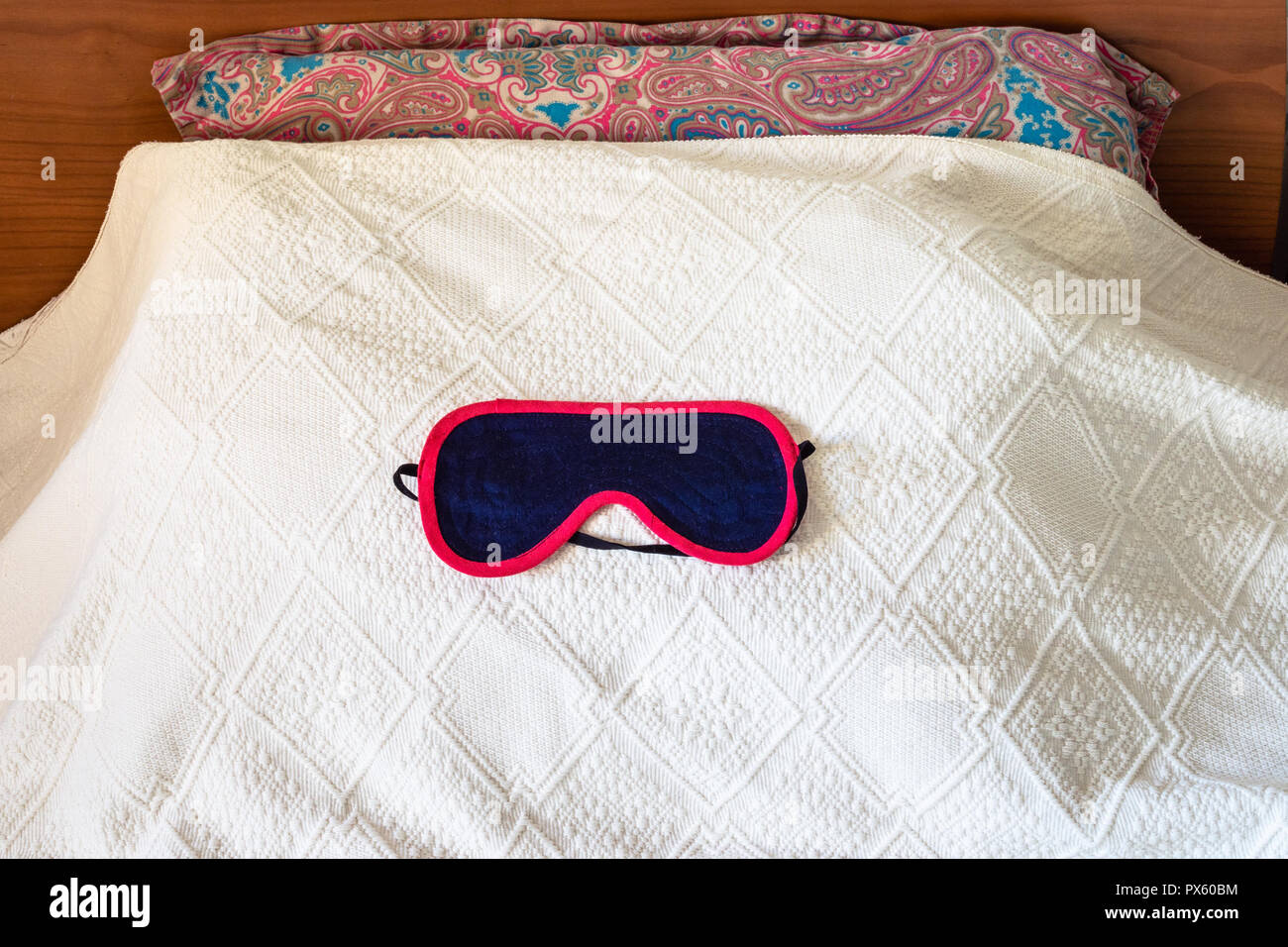 dark blue textile blindfold ( sleep mask ) on bed in bedroom Stock ...