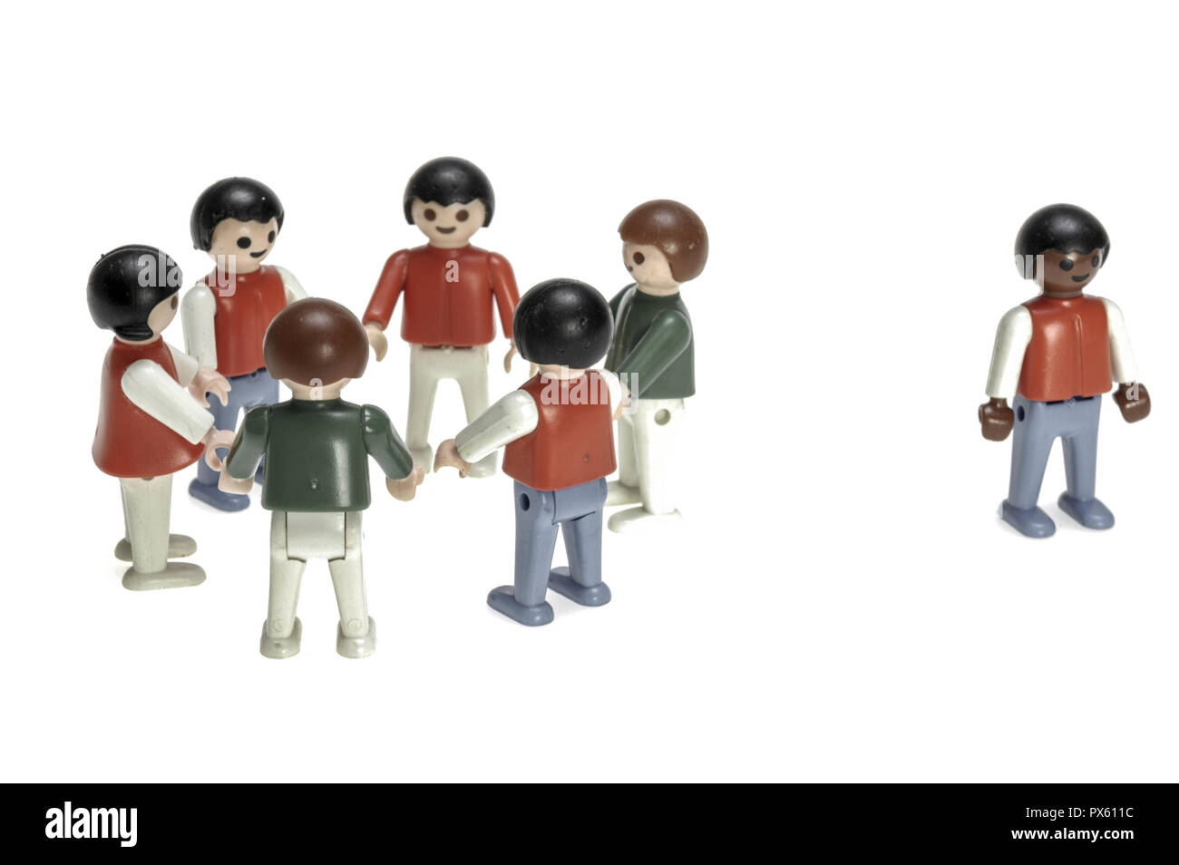 Group of white toy figures, circle, single black figure, excluded Stock ...