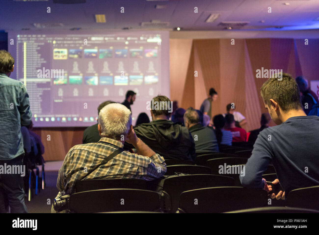 People listening to presentation at indoor conference Stock Photo - Alamy