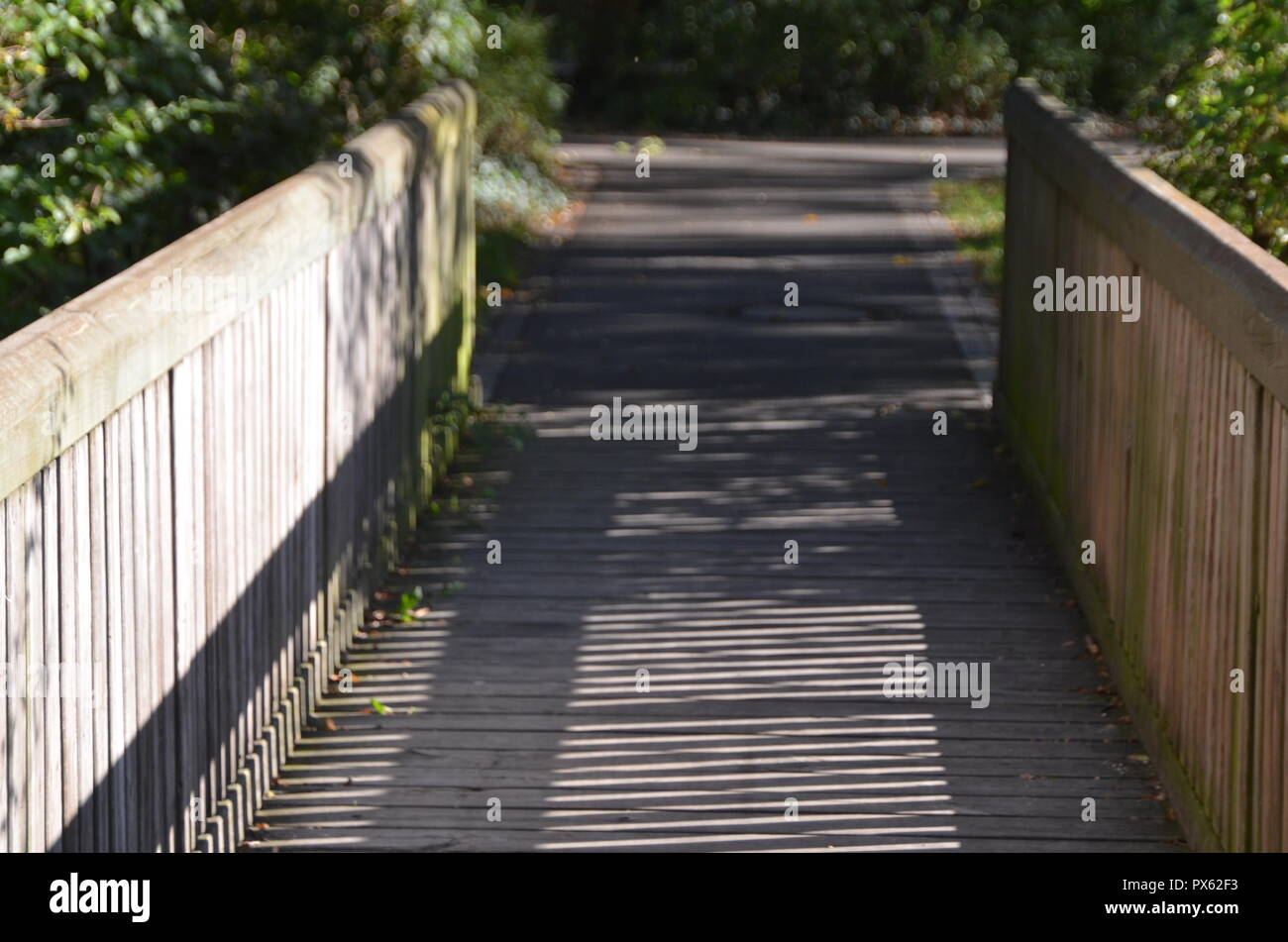 small wooden bridge from first person perspective as part of a path ...