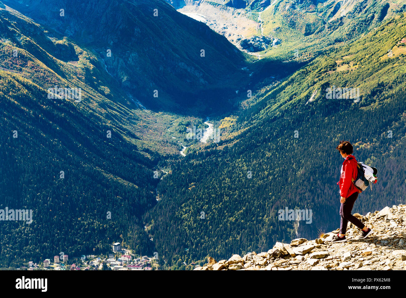 DOMBAY, RUSSIA - SEPTEMBER 22, 2018: tourist at the edge of cliff on Moussa-Achitara mount in ...