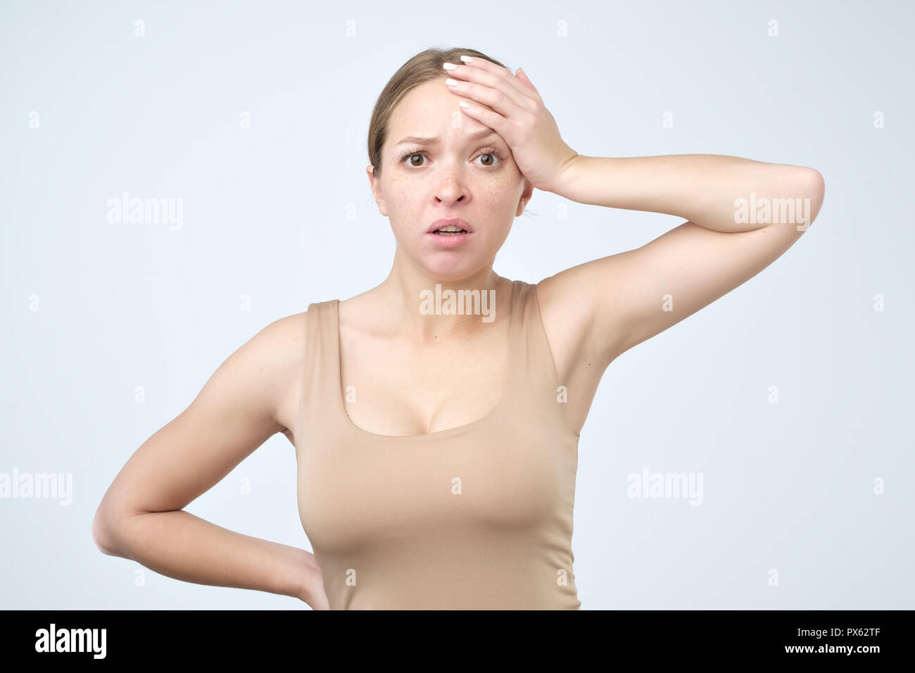 Young beautiful sad woman serious and concerned looking worried and ...