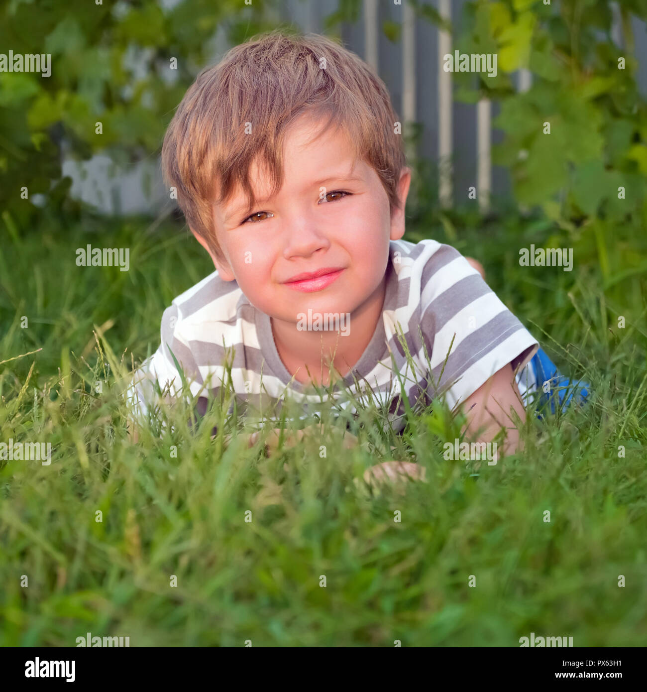 Cute kid having outside activities. Child on the grass Stock Photo - Alamy