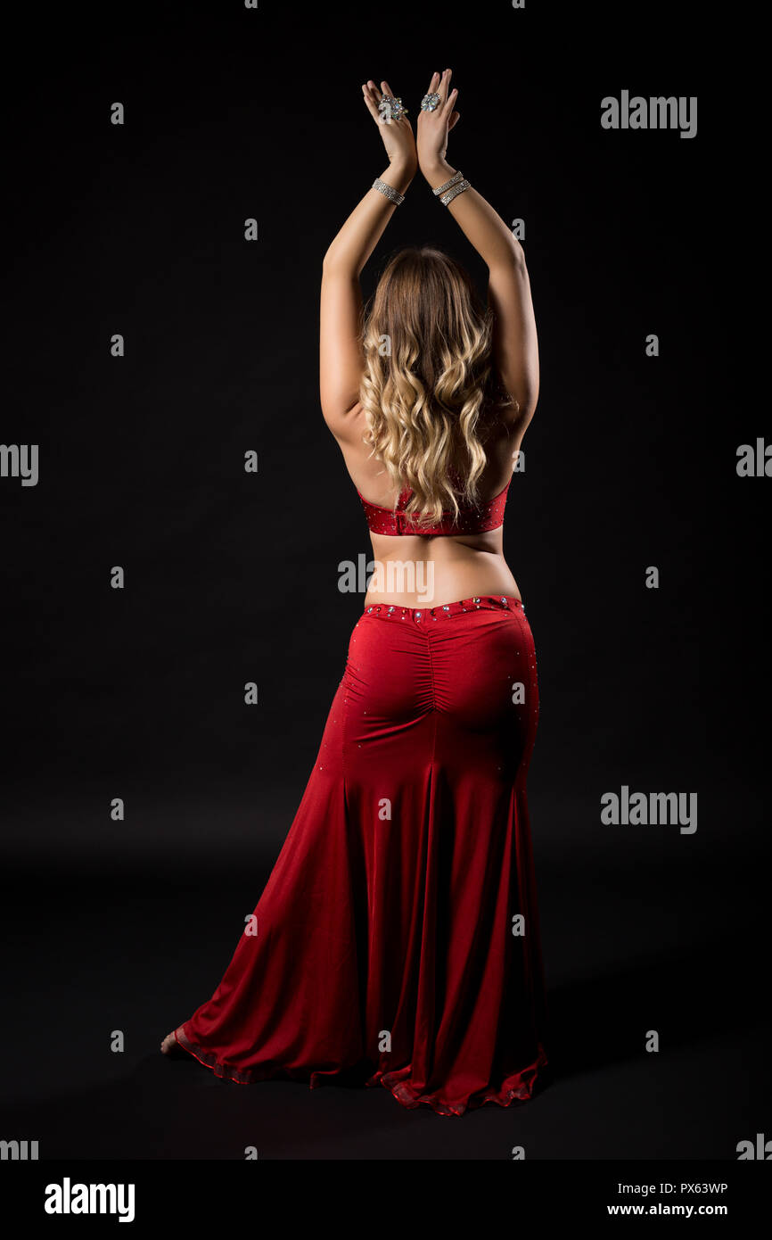 Belly dancer performing belly dance on black background Stock Photo - Alamy